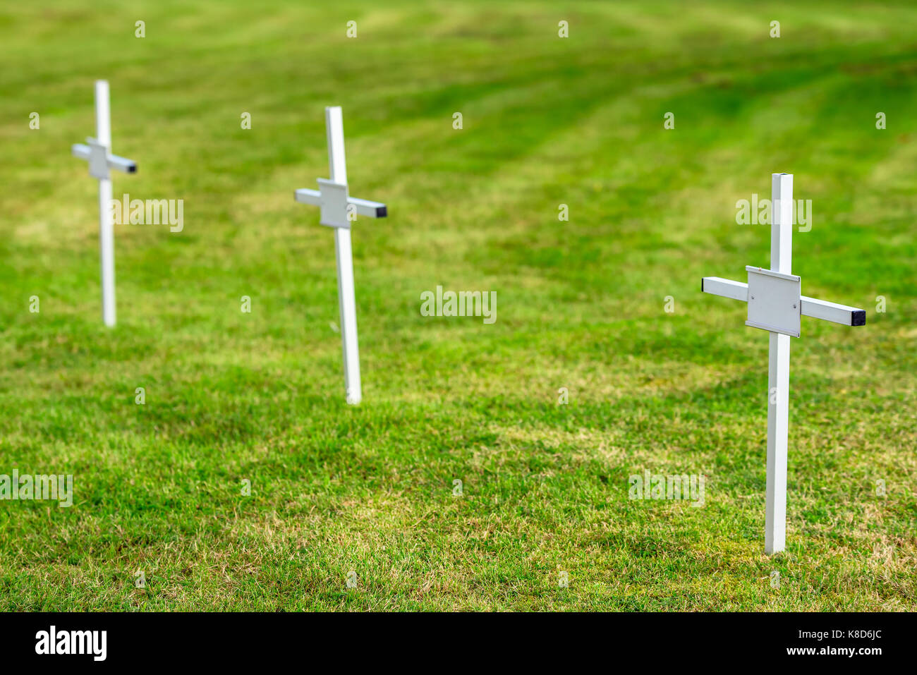Three temporary placed metal crosses on grass Stock Photo - Alamy