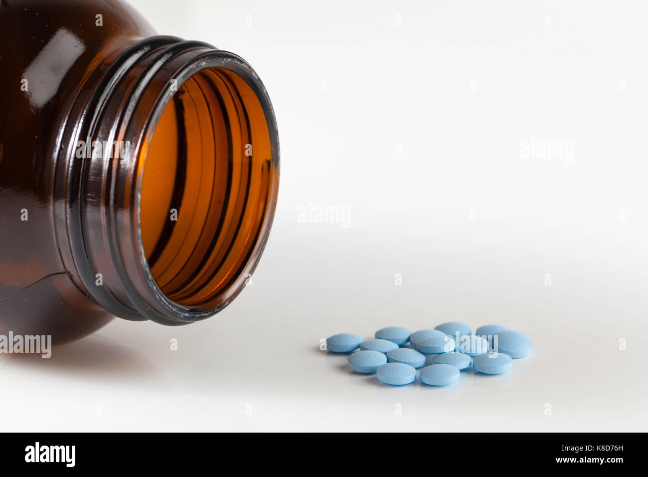 Blue drug pills on white table Stock Photo - Alamy
