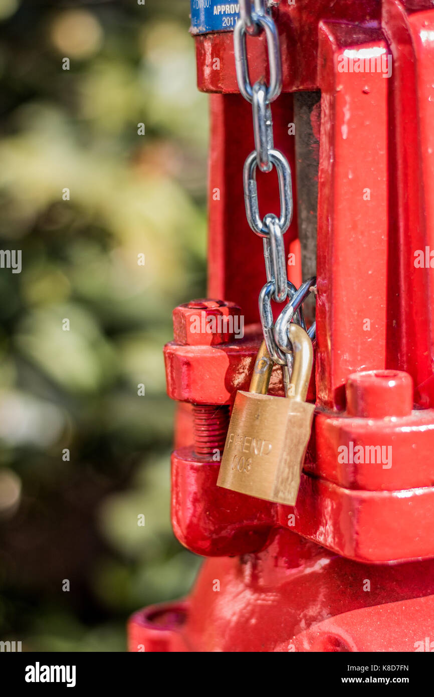 Padlock and chain on a red object Stock Photo - Alamy