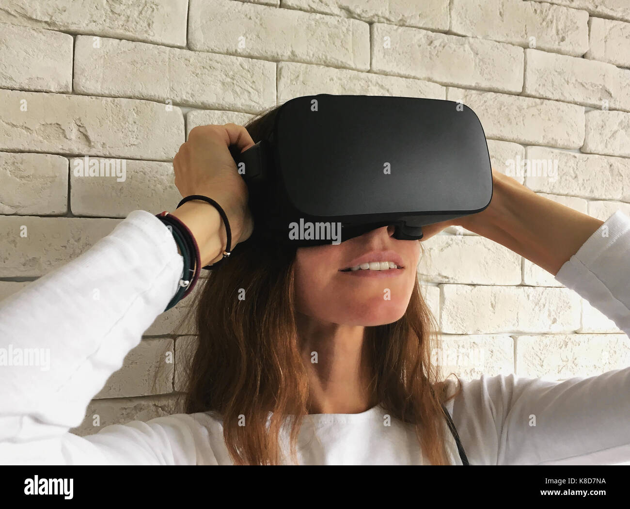 Young woman looking through virtual reality device Stock Photo - Alamy