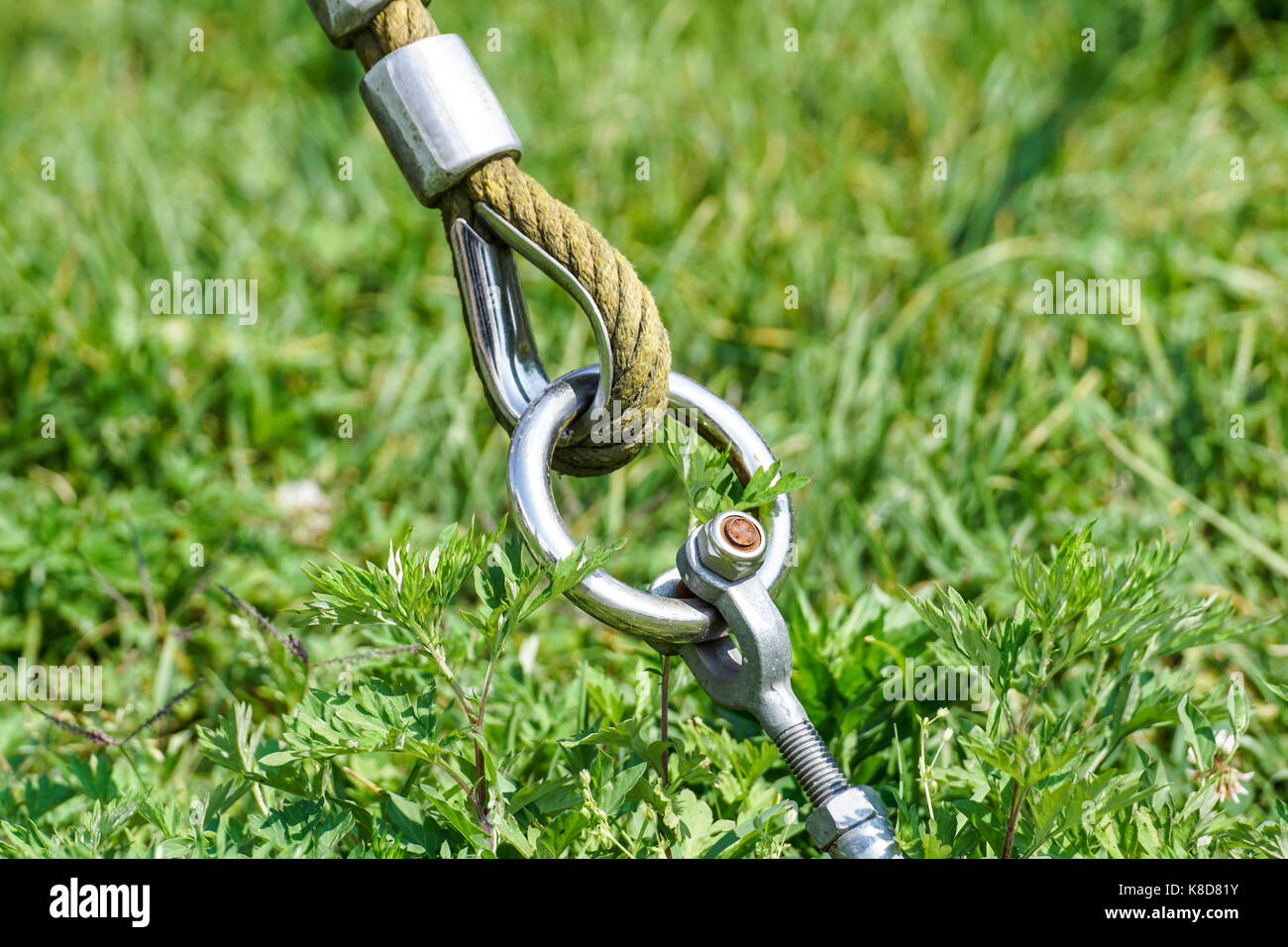 End of swinging rope hang on metal construction in a park. Rough rope ...