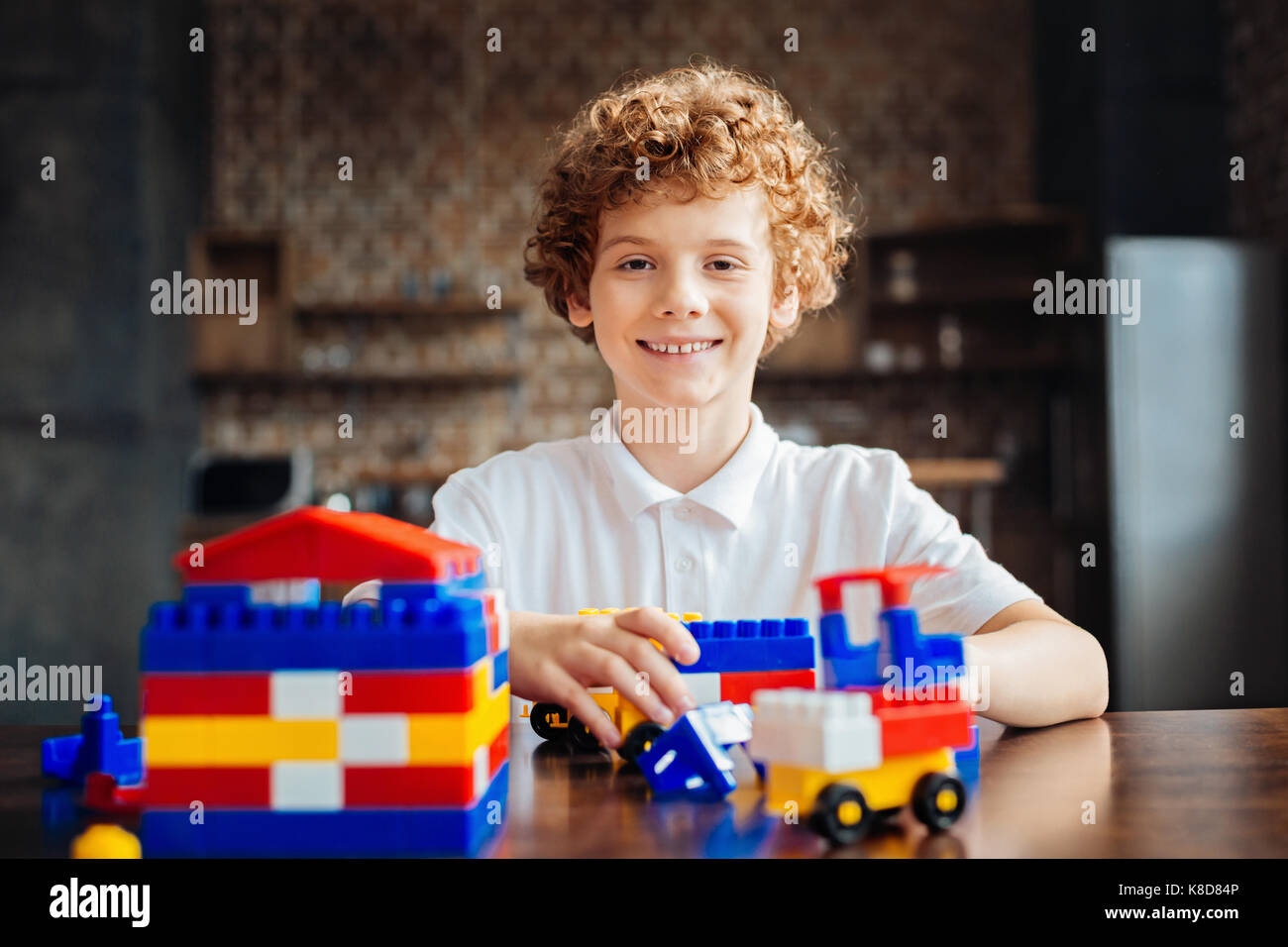 Cheerful boy grinning broadly while playing at home Stock Photo - Alamy