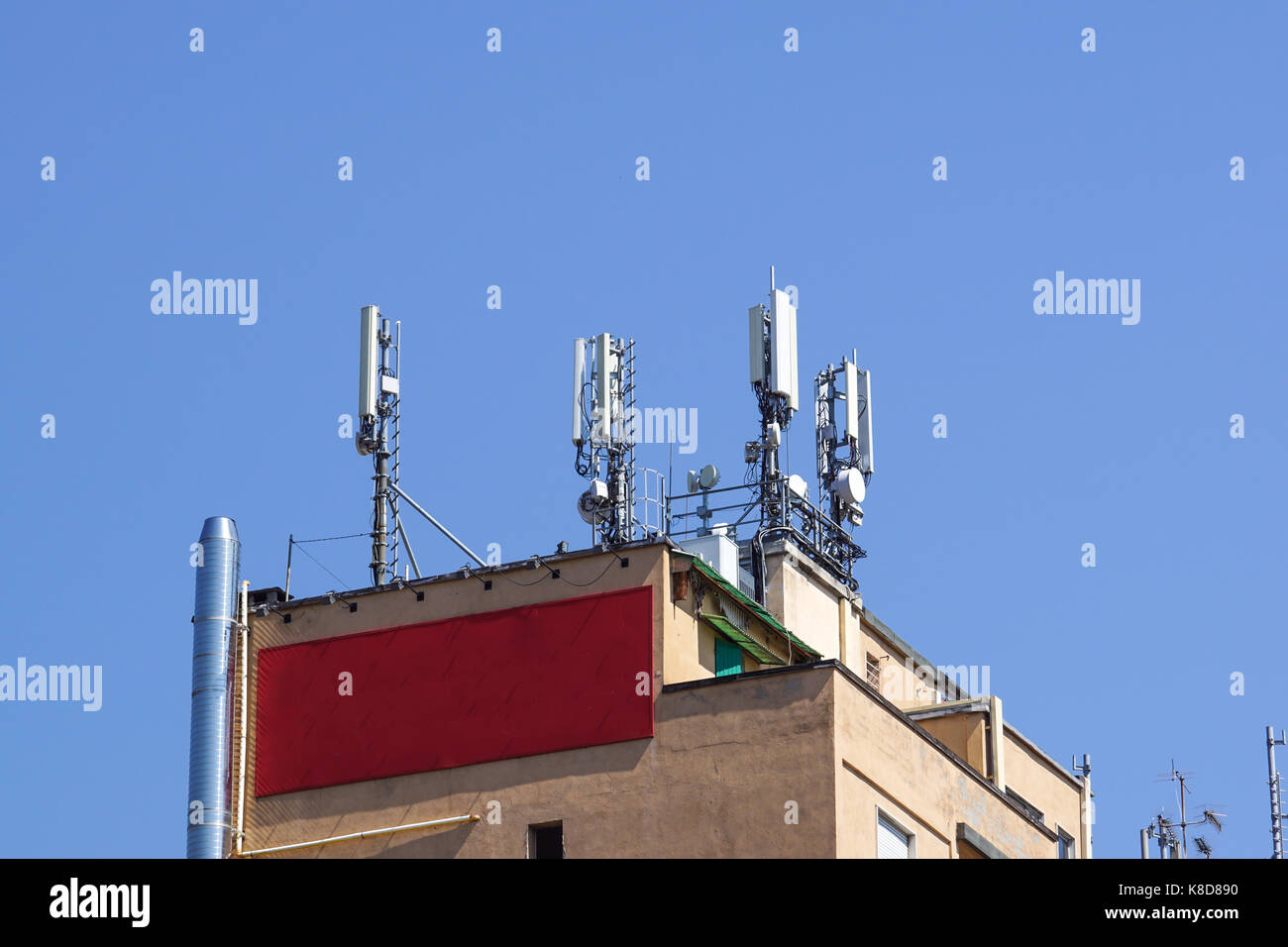 GSM transmitters on a roof of white administrative building. Close up ...