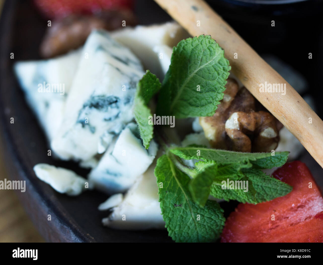 Italian chesse plate on black dish Stock Photo - Alamy
