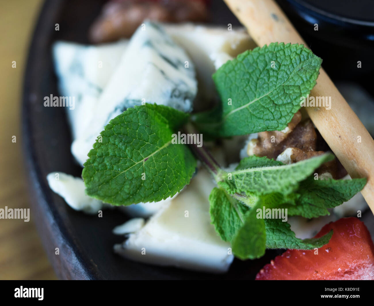 Italian chesse plate on black dish Stock Photo - Alamy