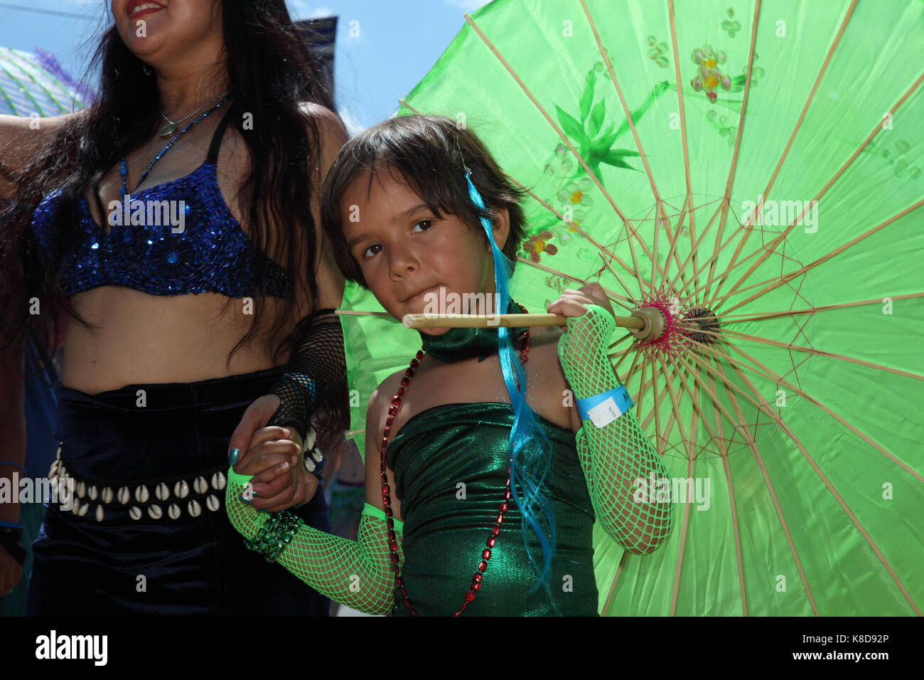 A young girl walks along the route during the annual Mermaid Parade in ...