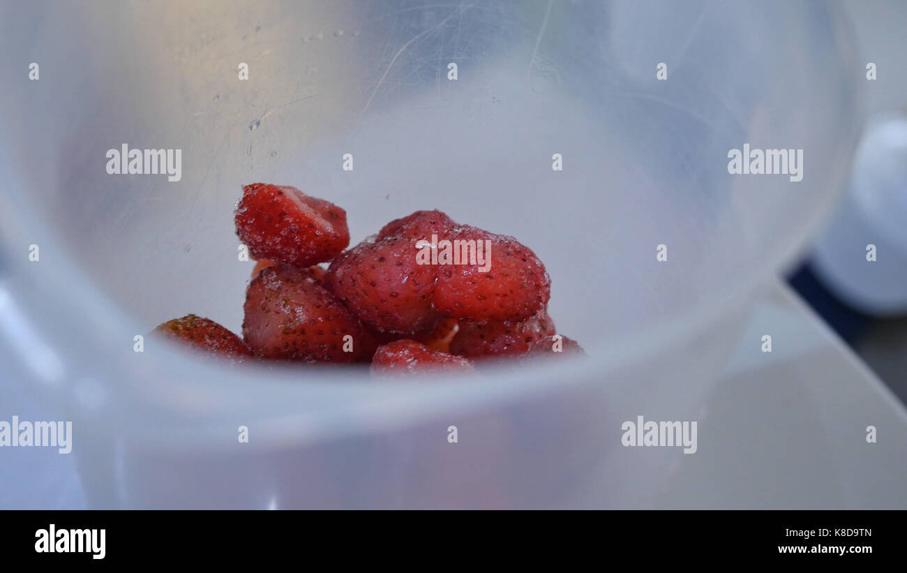 Diced strawberry inside a metric cup. Strawberries in a measuring Cup ...