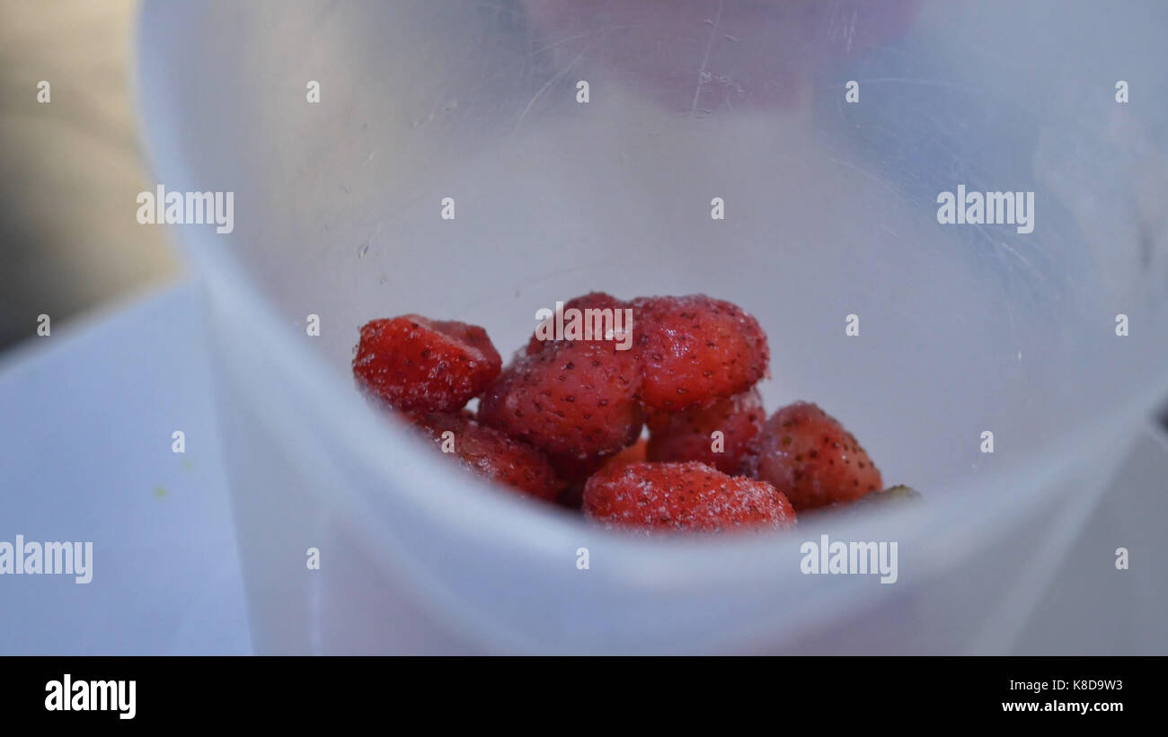 Diced strawberry inside a metric cup. Strawberries in a measuring Cup ...