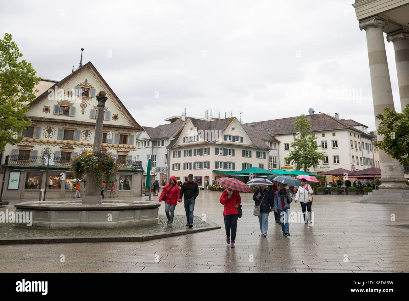 People walking in the inner city with umbrellas at a rainy day in ...