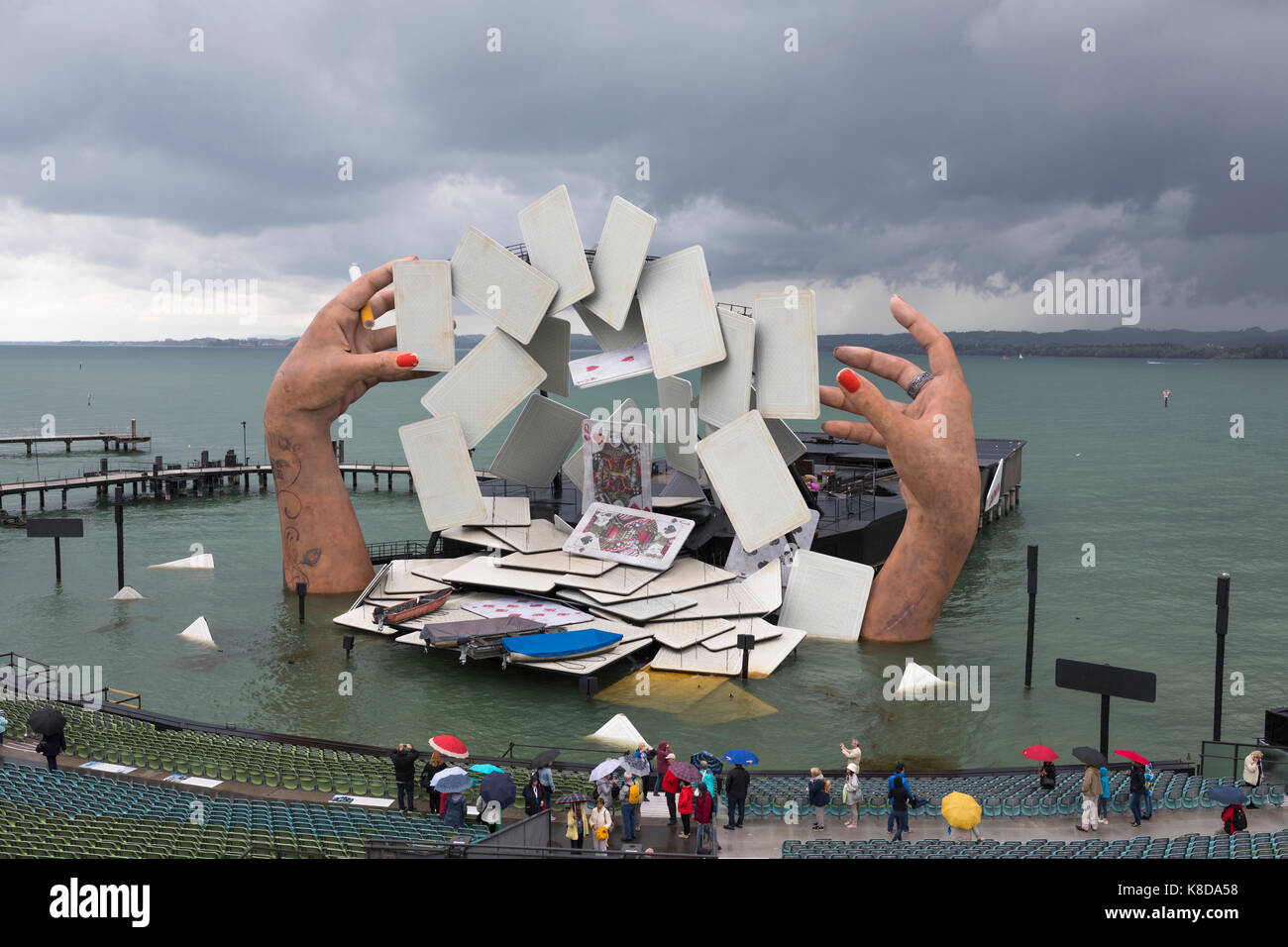 Tourists with umbrellas admire the stage of the " Bregenzer Festspiele ...