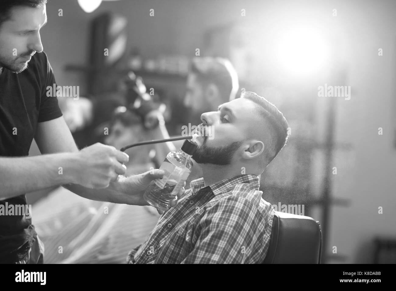 Young man at the barbershop Stock Photo - Alamy