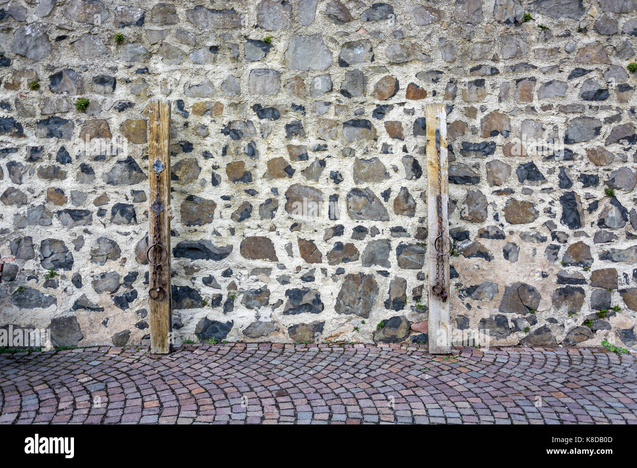 Two medieval prison chains for prisoners in front of stone wall Stock ...