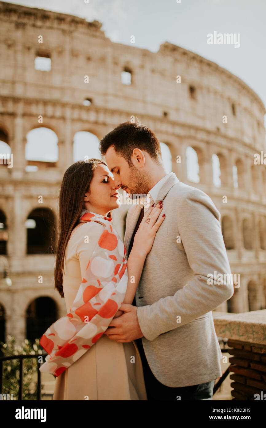 Loving couple visiting Italian famous landmarks Colosseum in Rome ...