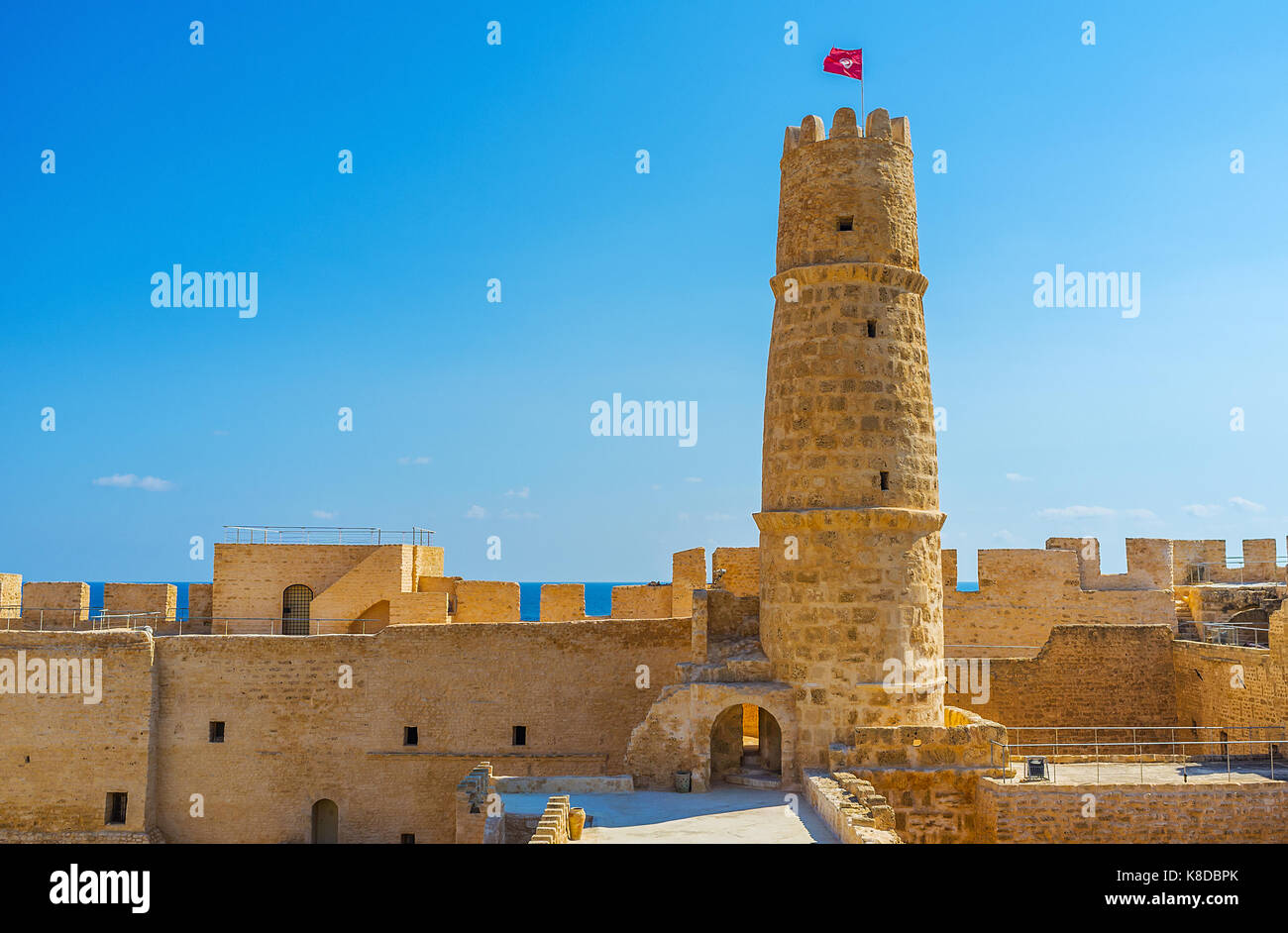 The tallest tower of Ribat with Tunisian flag on the top, the huge ...