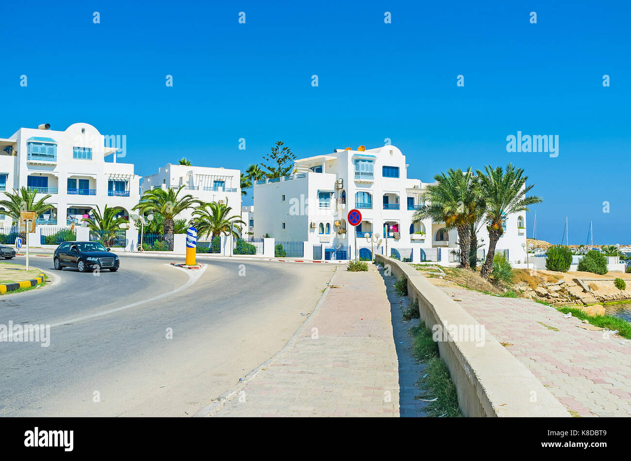 The modern white cottages on the coast of resort, next to the yacht ...