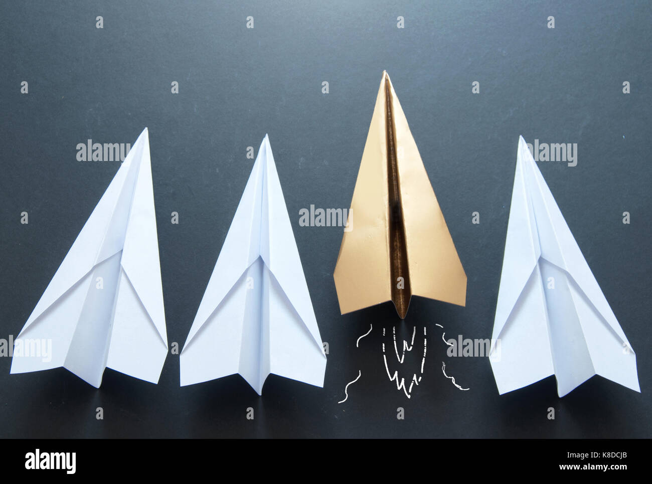 Gold paper plane standing out in a line Stock Photo - Alamy