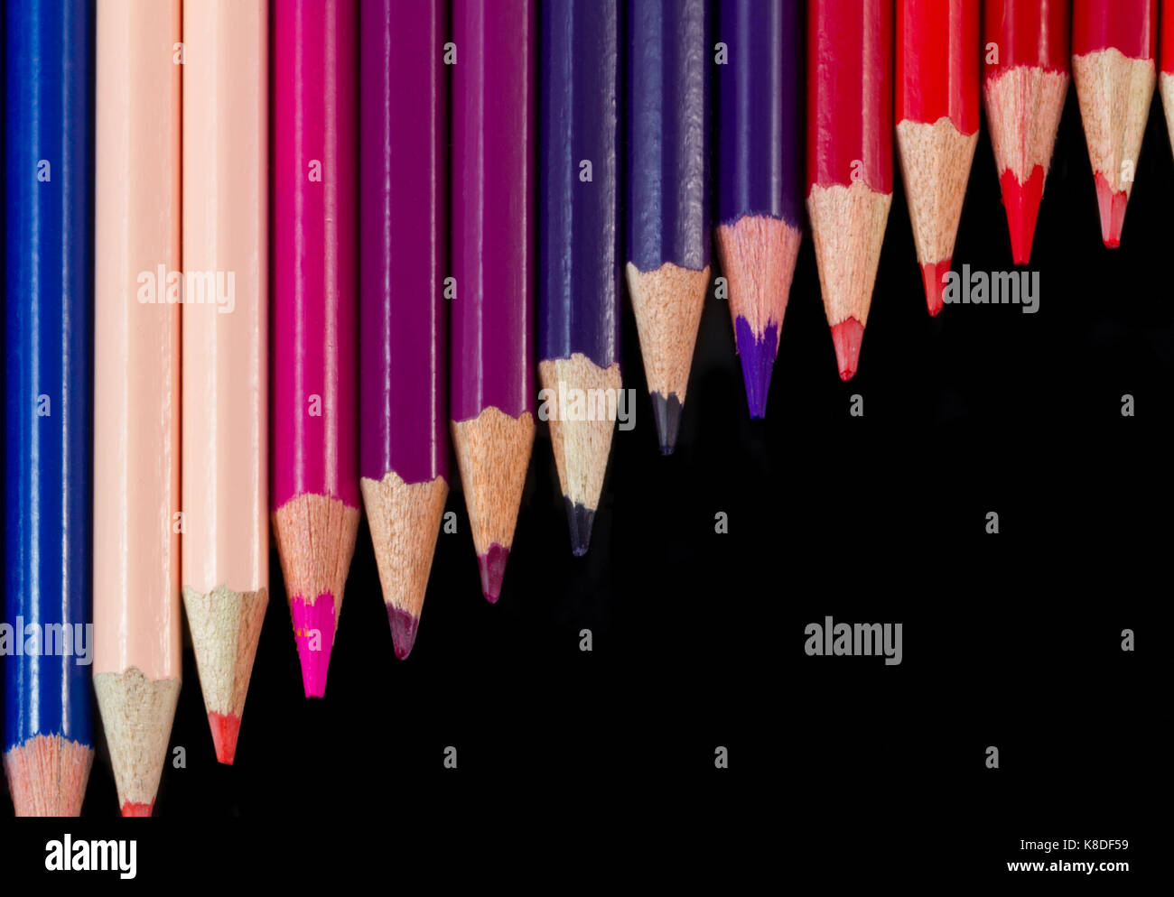 Color pencils isolated on black background with warm palette. Shot at ...
