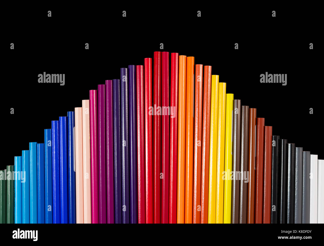 Color pencils isolated on black background in arc formation. Shot at ...