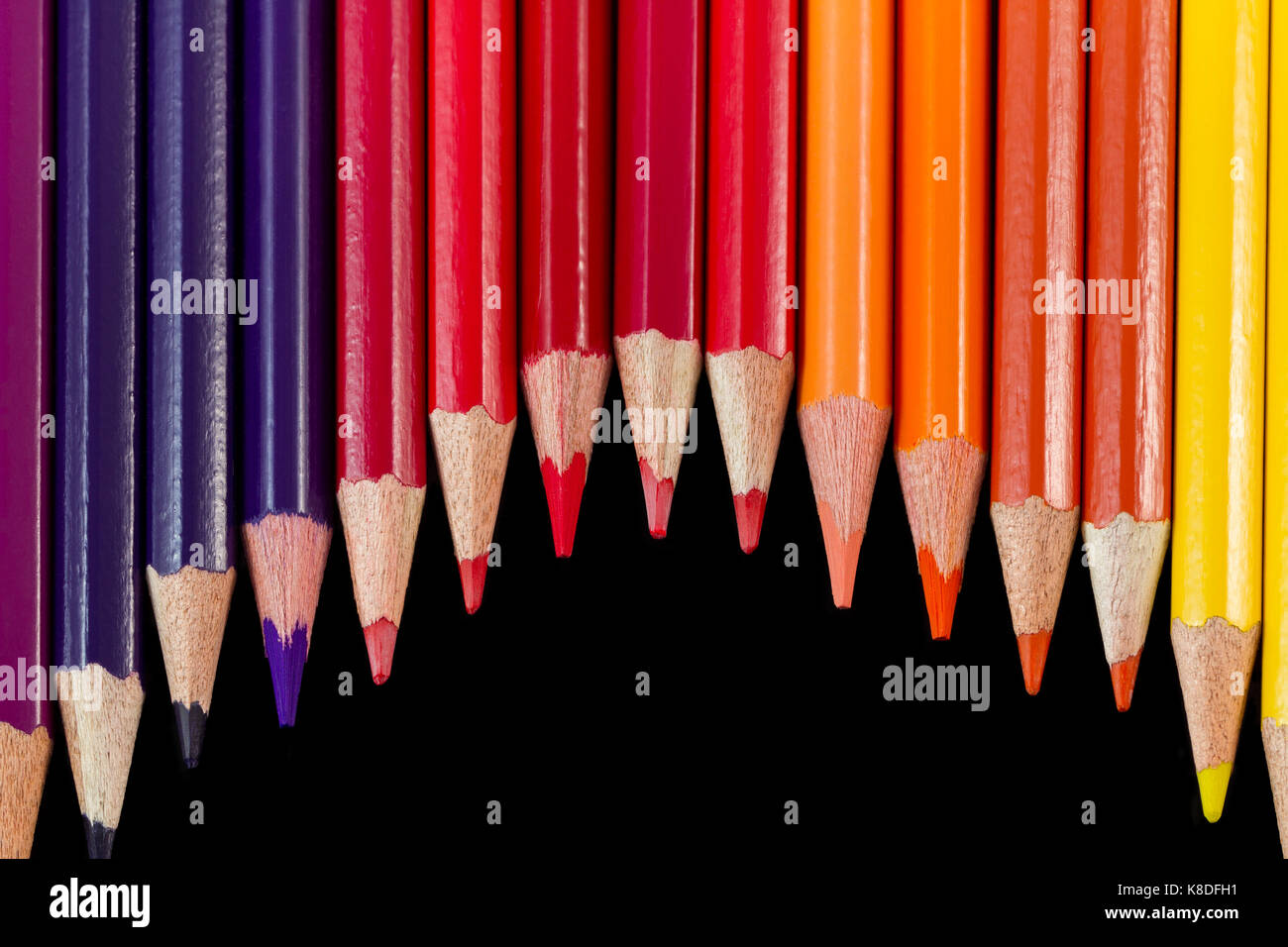Color pencils isolated on black background in wave formation. Shot at ...