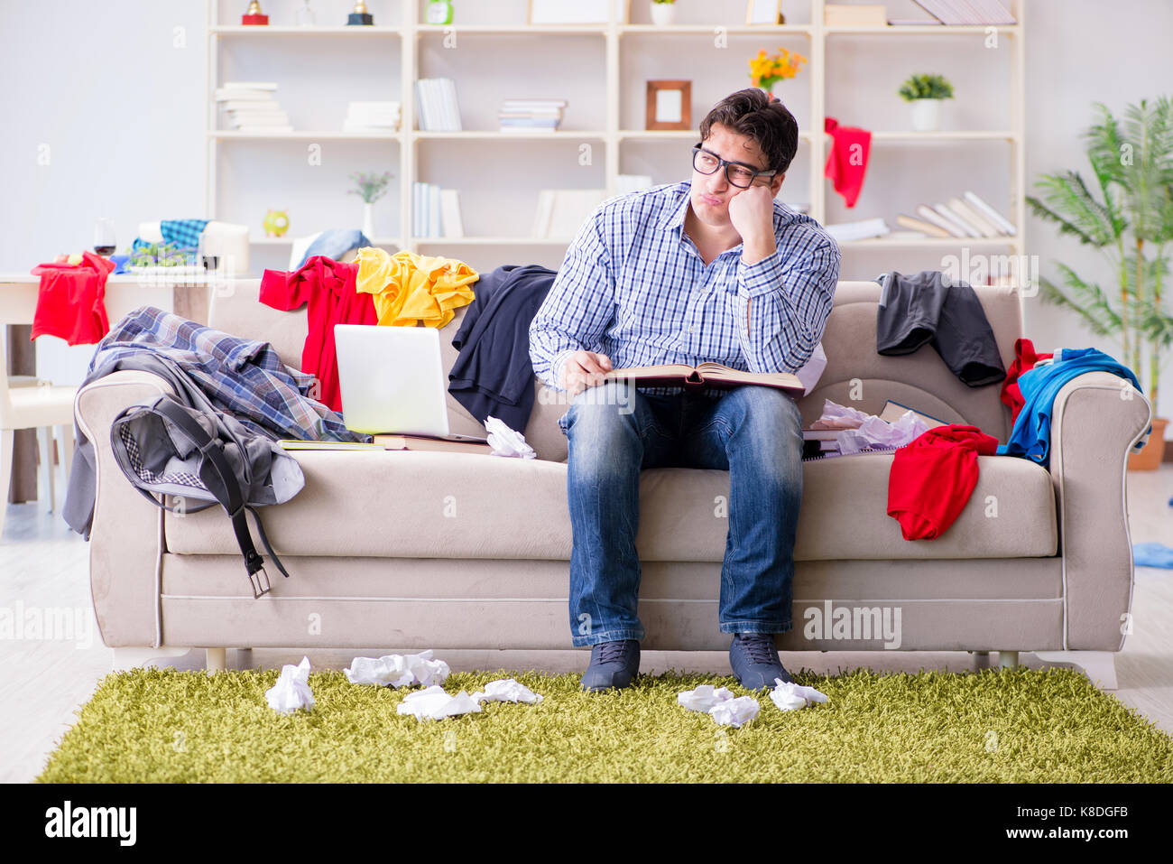 Young man working studying in messy room Stock Photo - Alamy