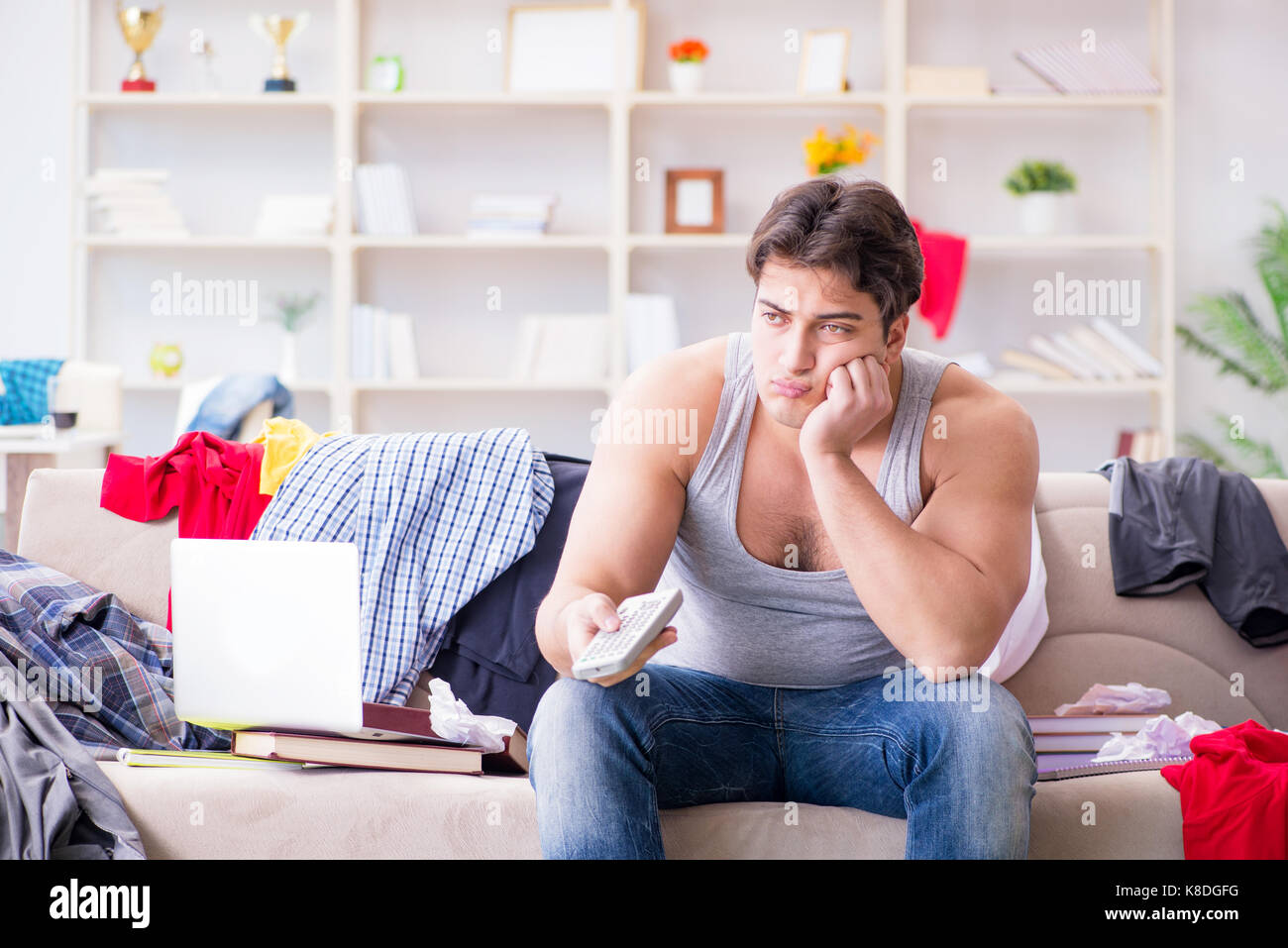 Young man working studying in messy room Stock Photo - Alamy