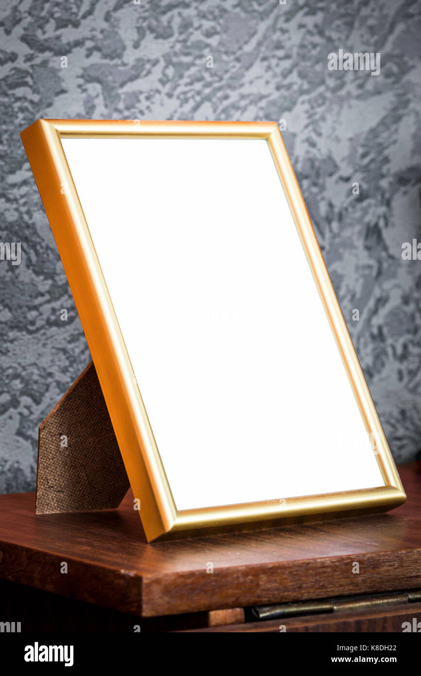 An empty wooden photo frame stands on the table Stock Photo - Alamy