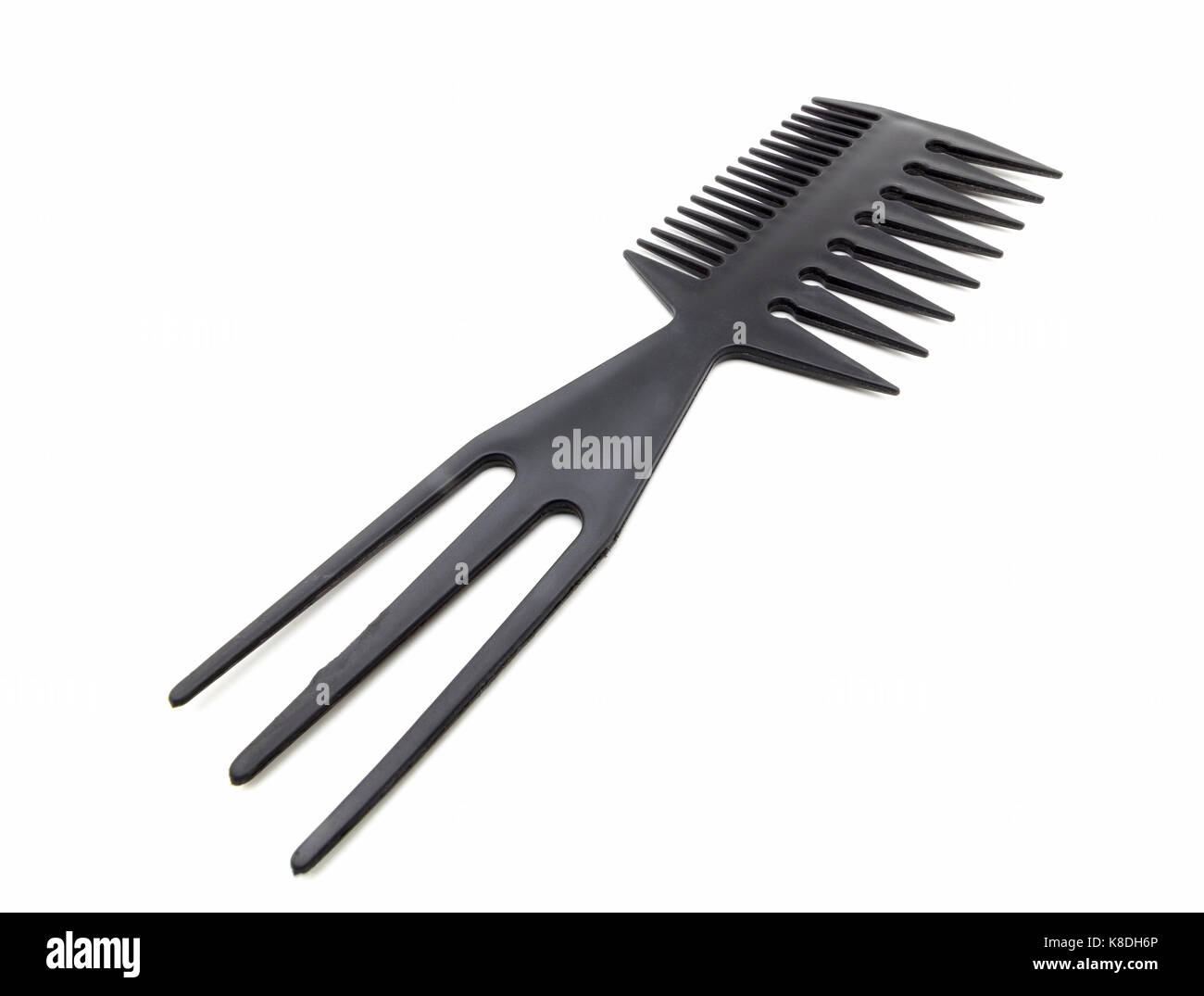 Black plastic comb close-up on a white background Stock Photo - Alamy