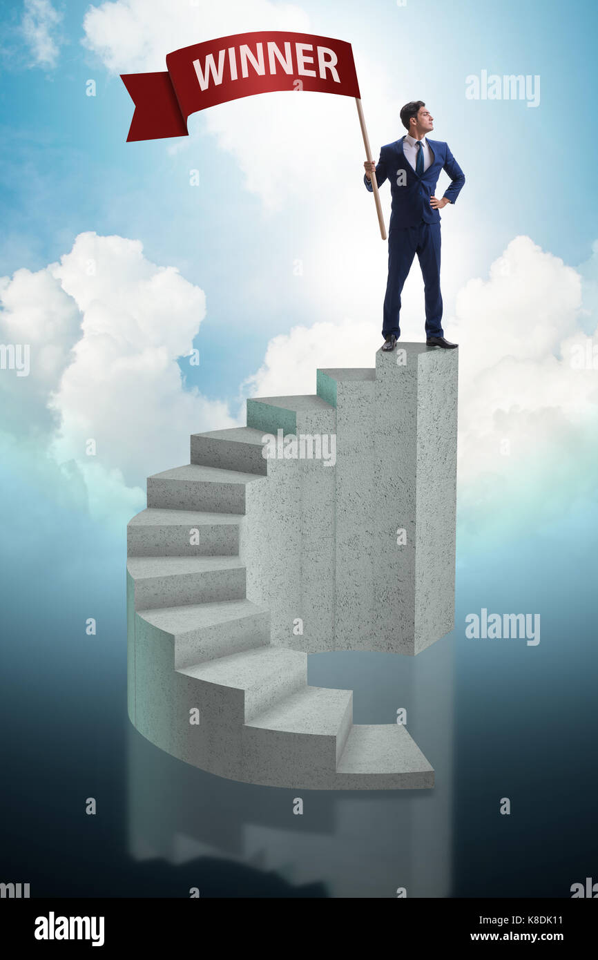 Businessman winner on top of staircase Stock Photo - Alamy