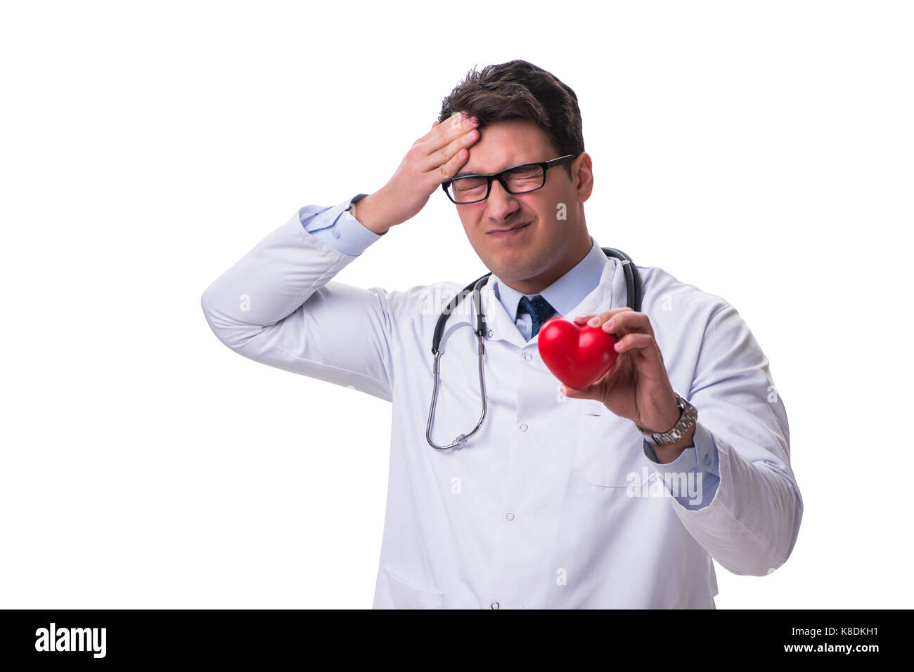 Young male cardiologist doctor holding a heart isolated on white ...