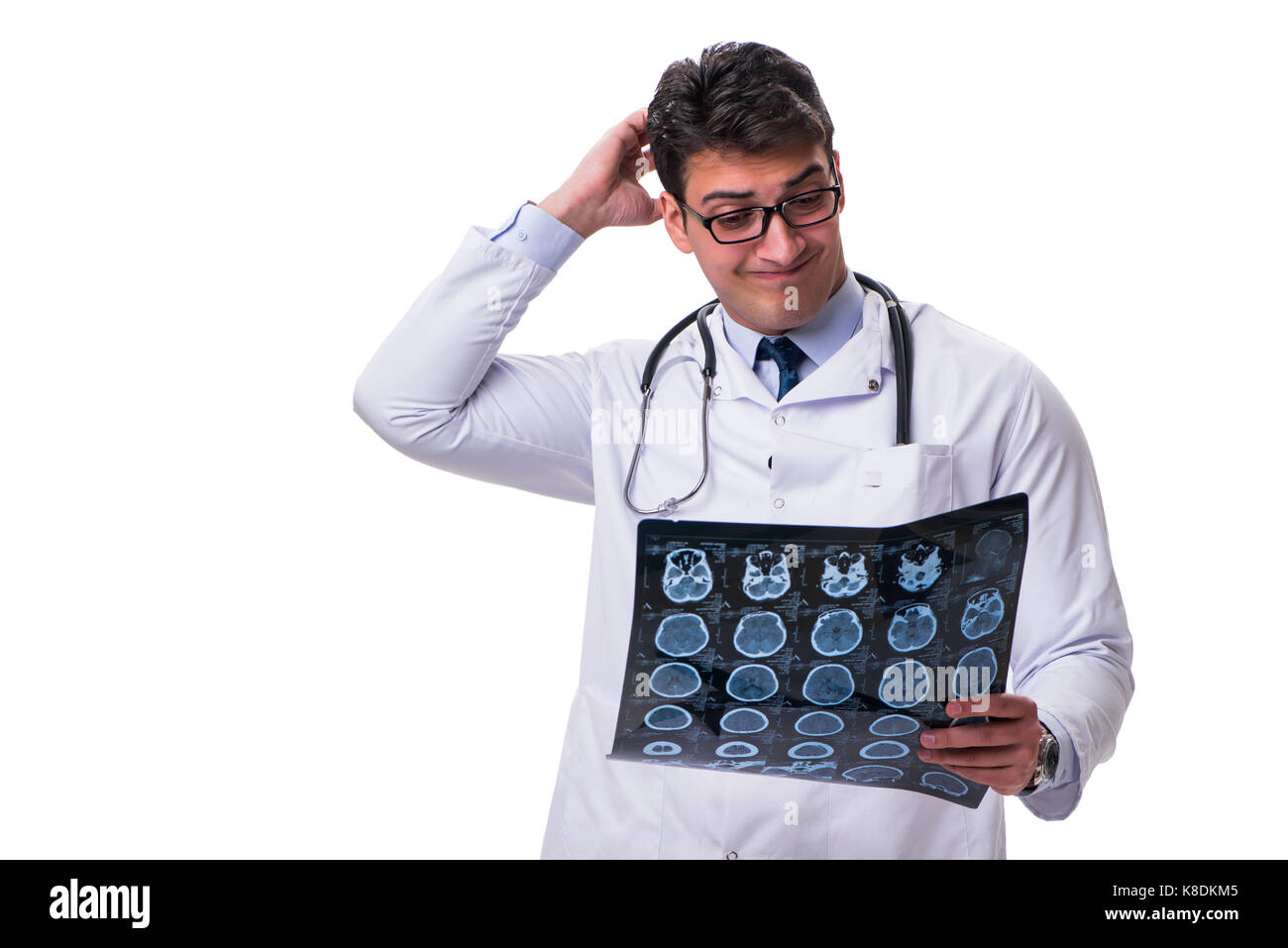 Young male doctor holding a radiograph isolated on white background ...