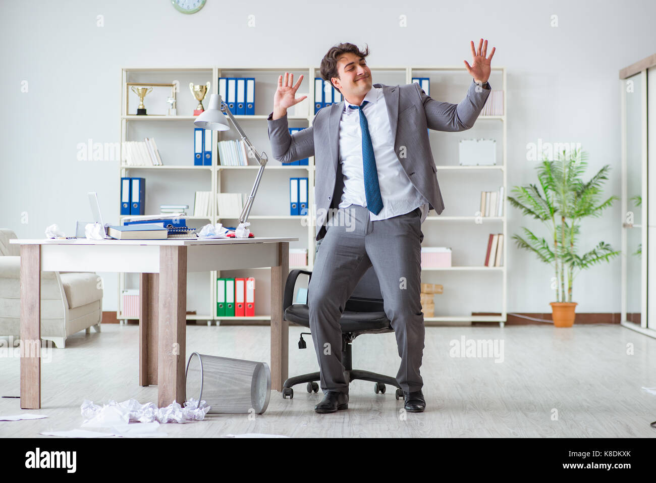 Businessman having fun taking a break in the office at work Stock Photo ...