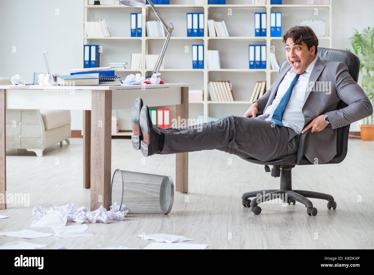 Businessman having fun taking a break in the office at work Stock Photo ...