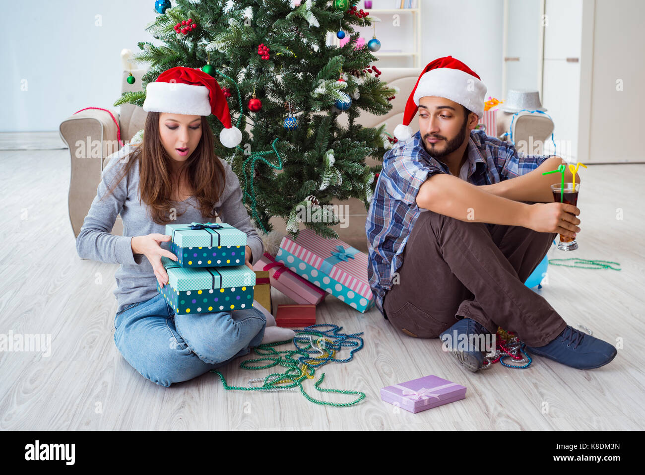 Girlfriend and boyfriend opening christmas gifts Stock Photo - Alamy