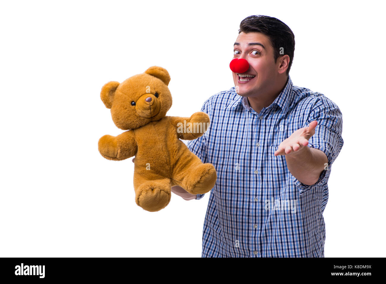 Funny clown man with a soft teddy bear toy isolated on white background ...