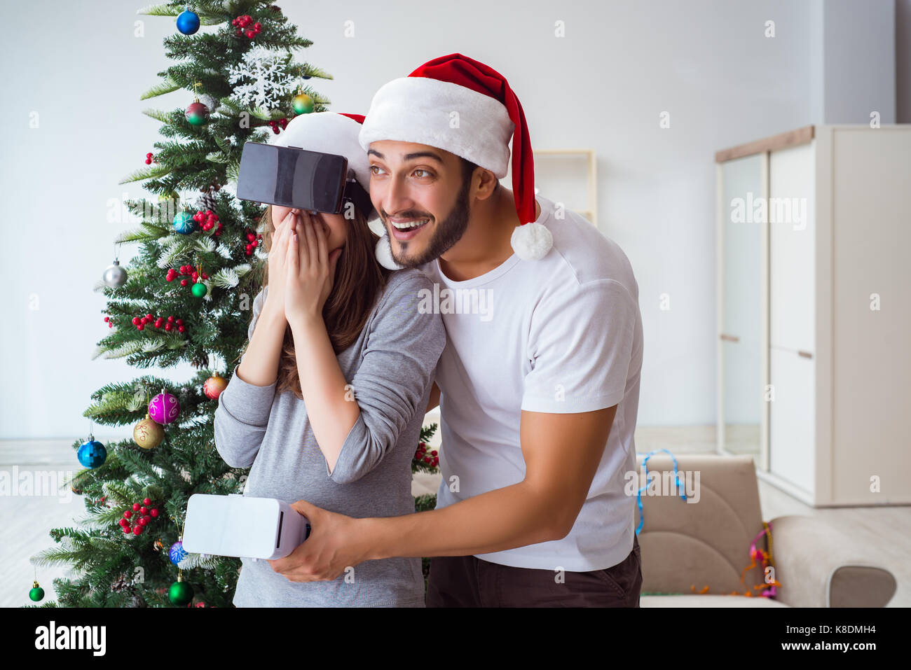 Young family expecting child baby wearing virtual reality VR glasses ...