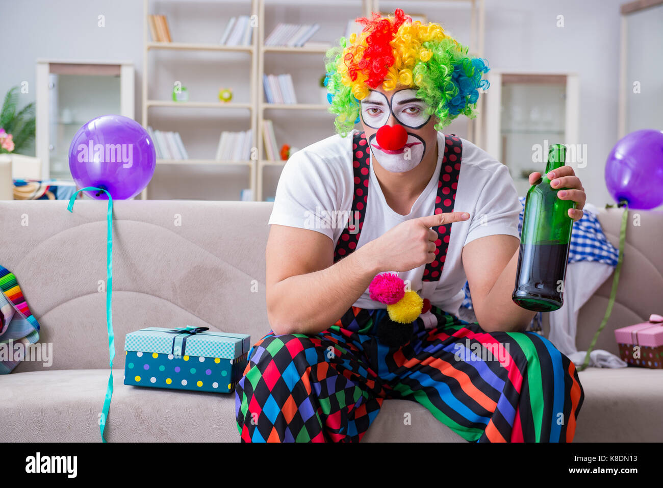Drunk clown celebrating having a party at home Stock Photo - Alamy