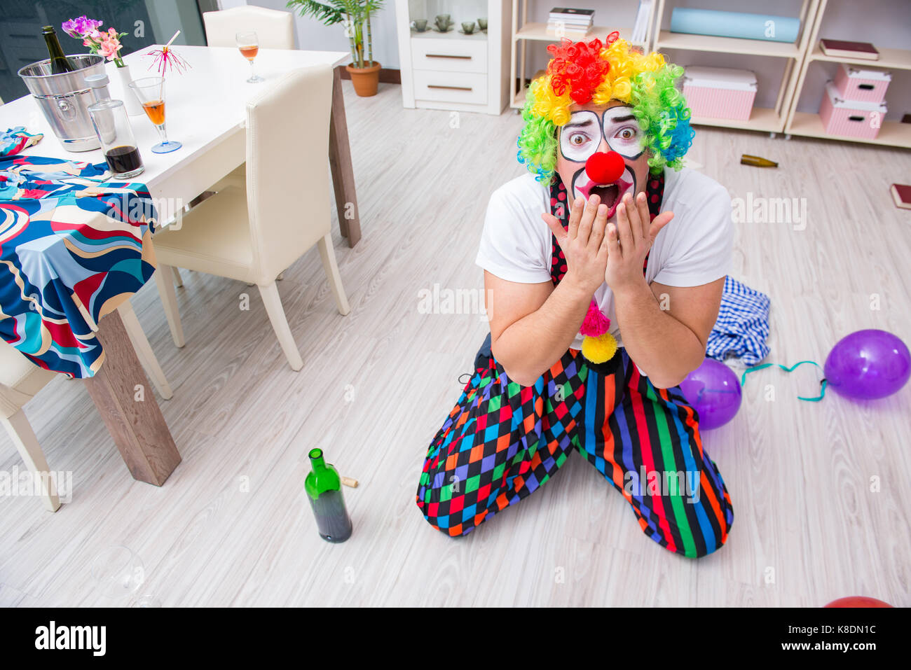 Drunk clown celebrating having a party at home Stock Photo - Alamy