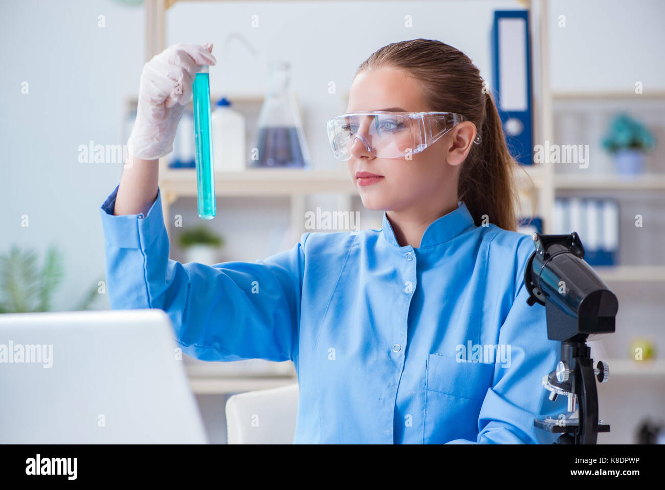 Female scientist researcher conducting an experiment in a laboratory ...
