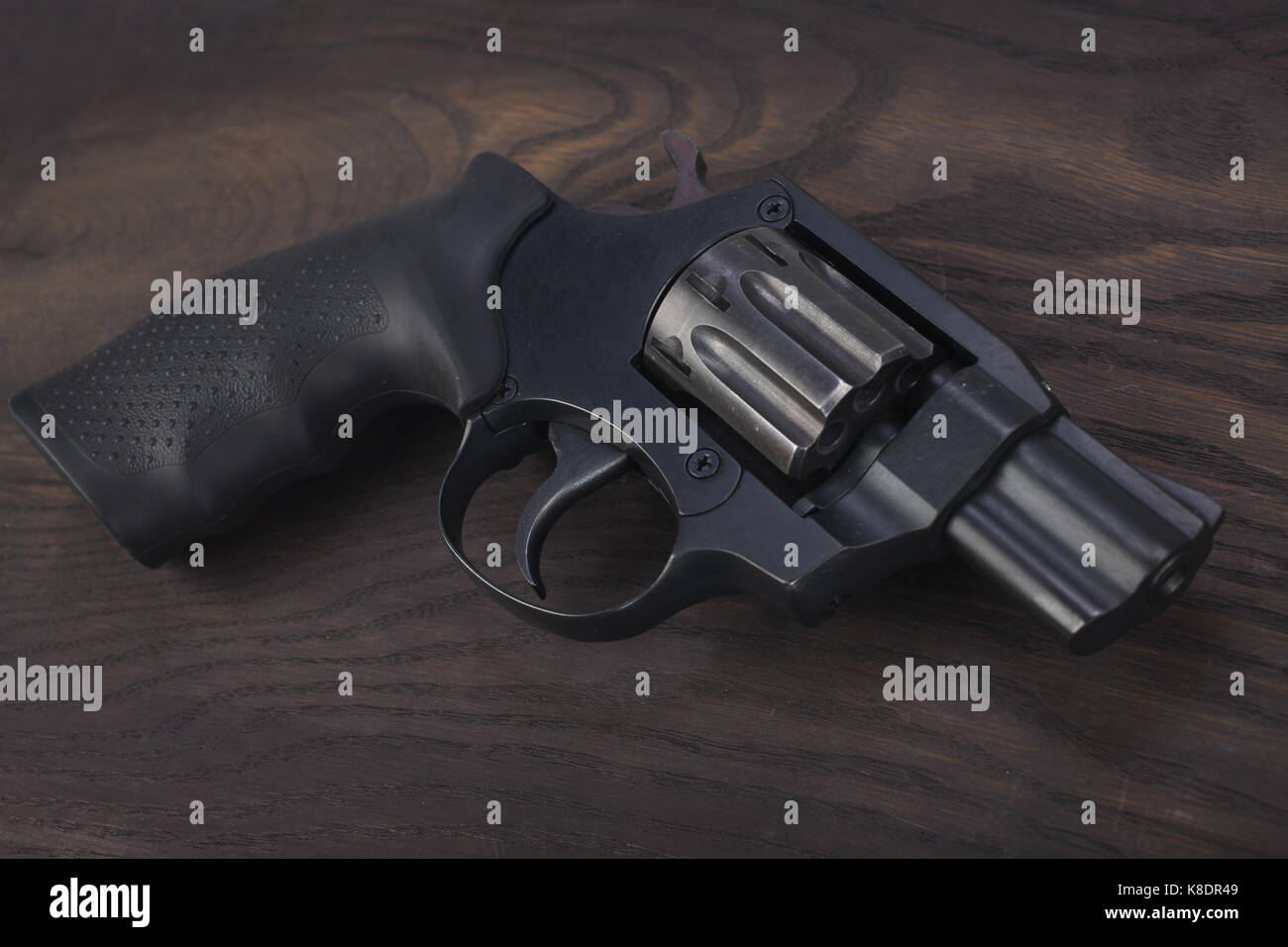 Revolver on the wooden table Stock Photo - Alamy