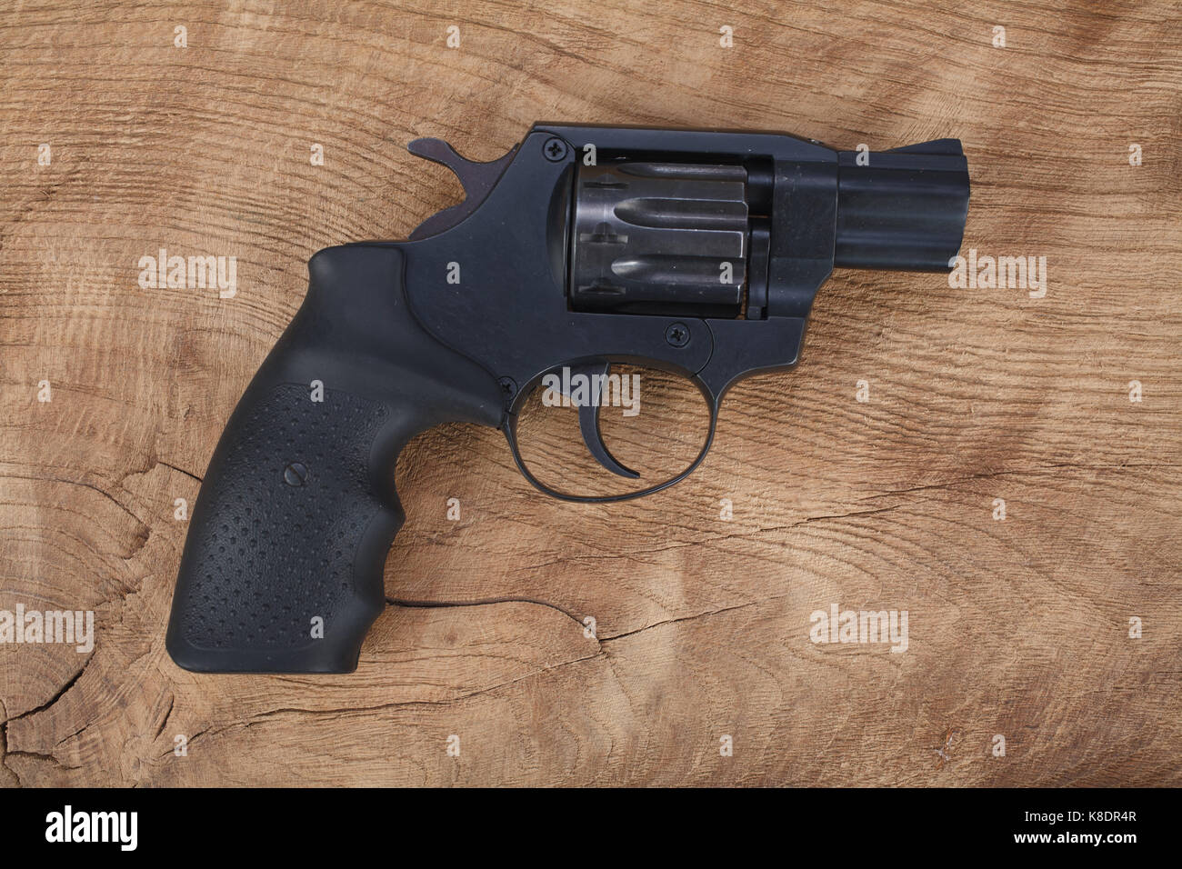 Revolver on the wooden table Stock Photo - Alamy