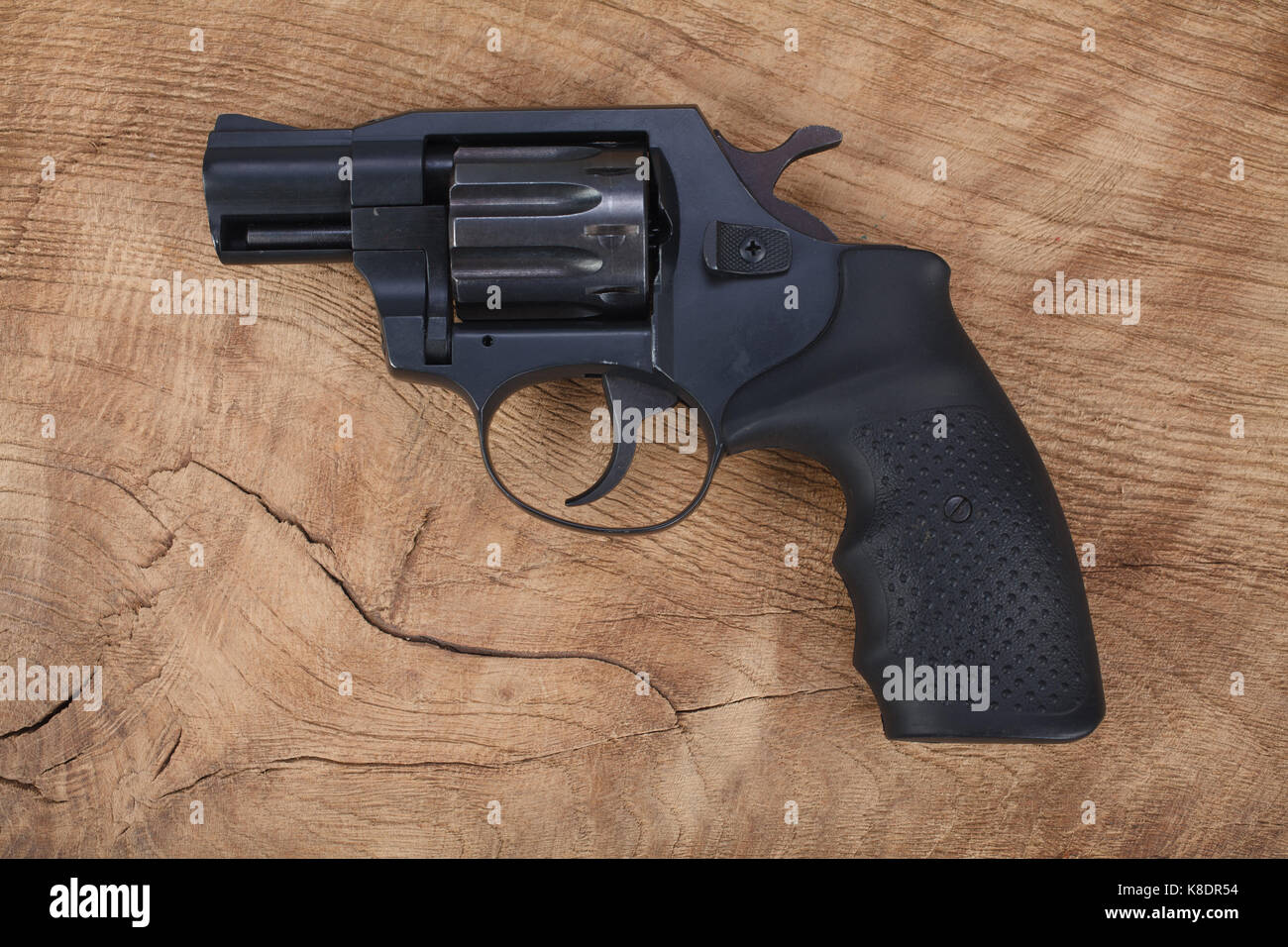Revolver on the wooden table Stock Photo - Alamy