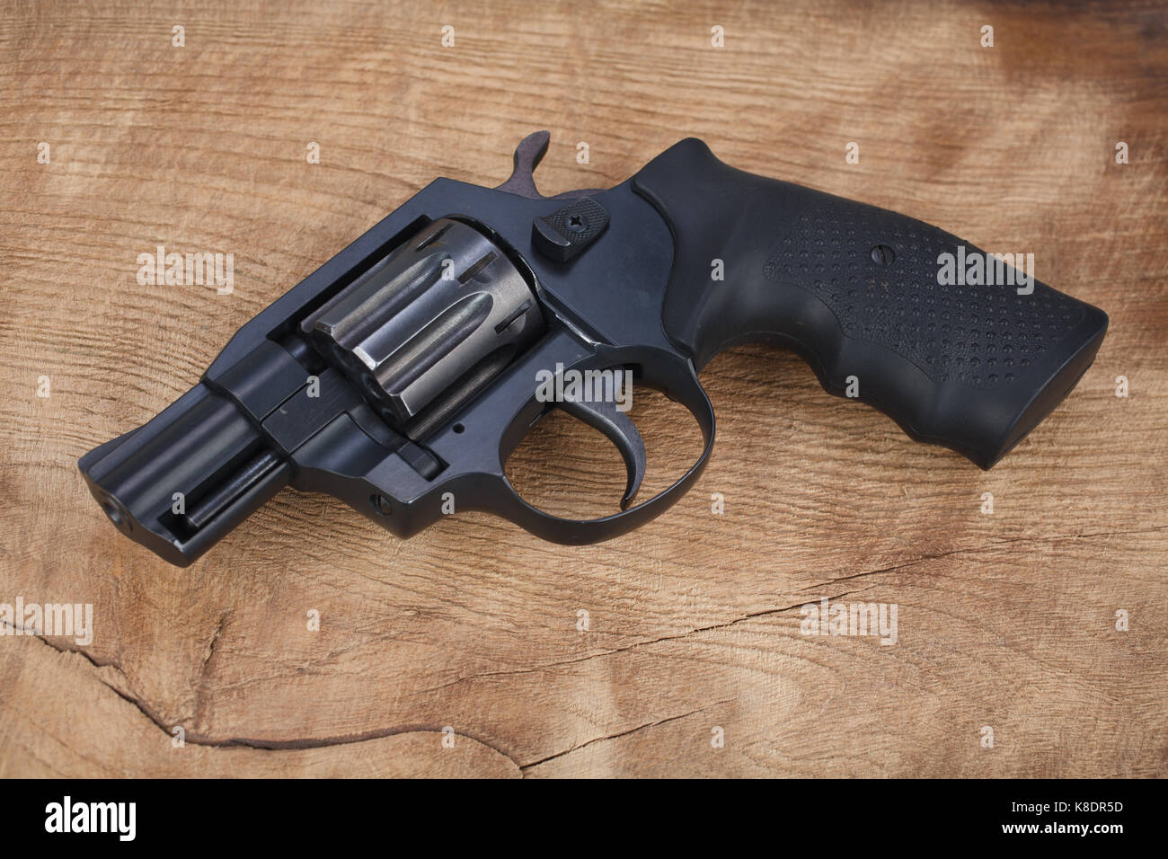 Revolver on the wooden table Stock Photo - Alamy