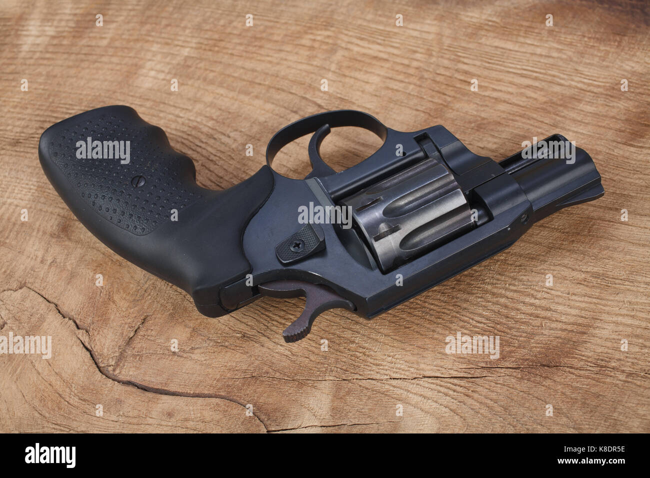 Revolver on the wooden table Stock Photo - Alamy