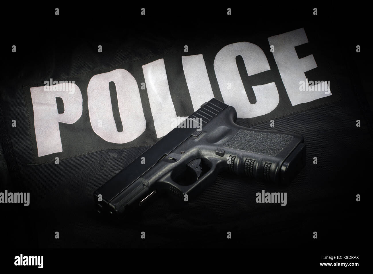 Police weapon and equipment on black uniform background Stock Photo - Alamy