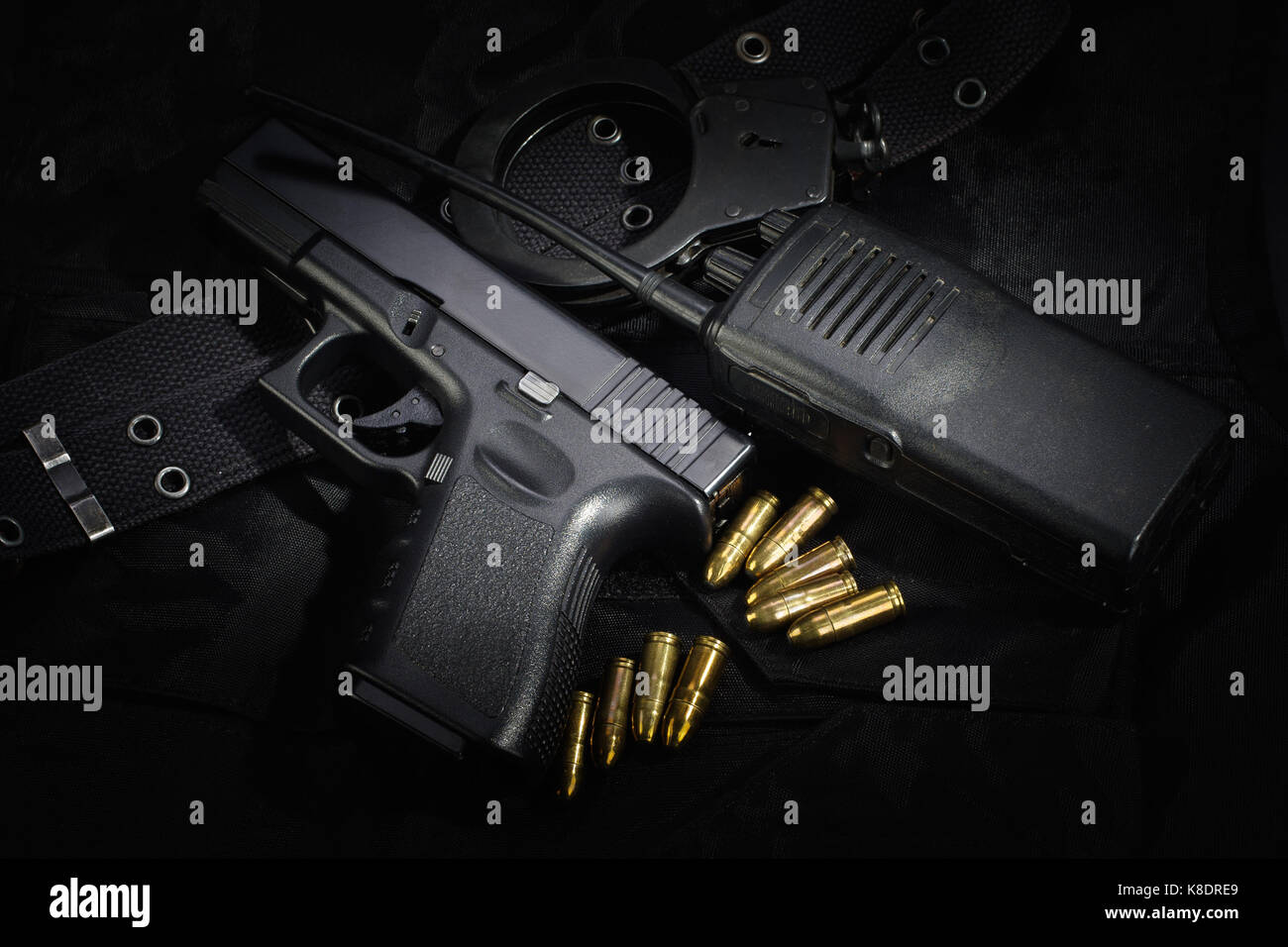 Police weapon and equipment on black uniform background Stock Photo - Alamy