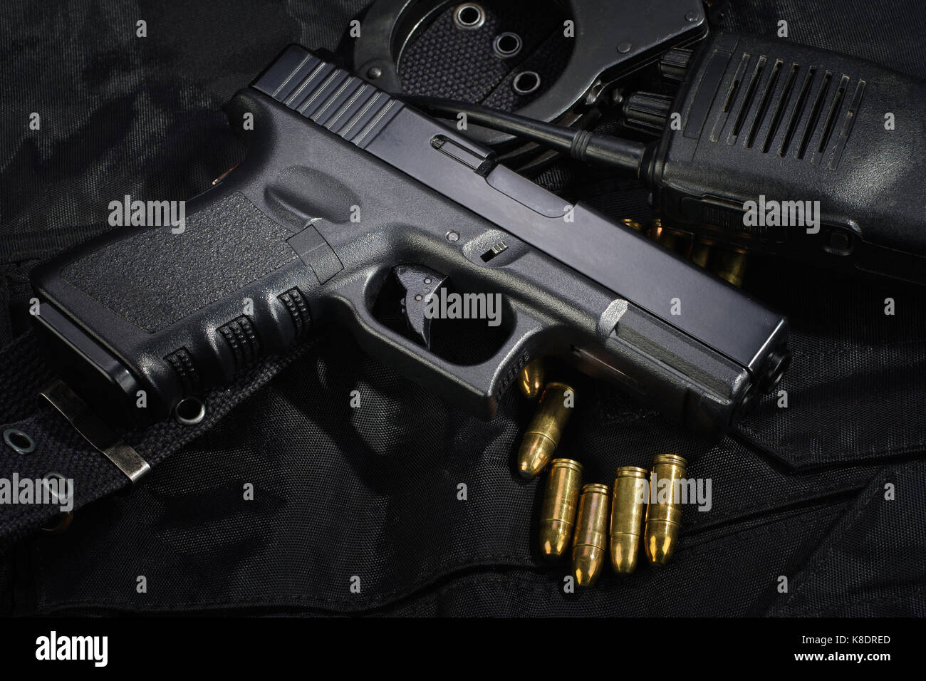 Police weapon and equipment on black uniform background Stock Photo - Alamy