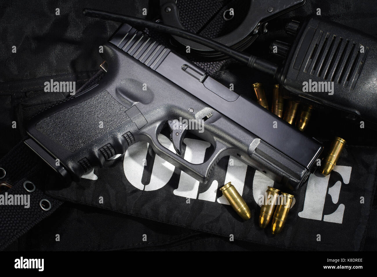 Police weapon and equipment on black uniform background Stock Photo - Alamy