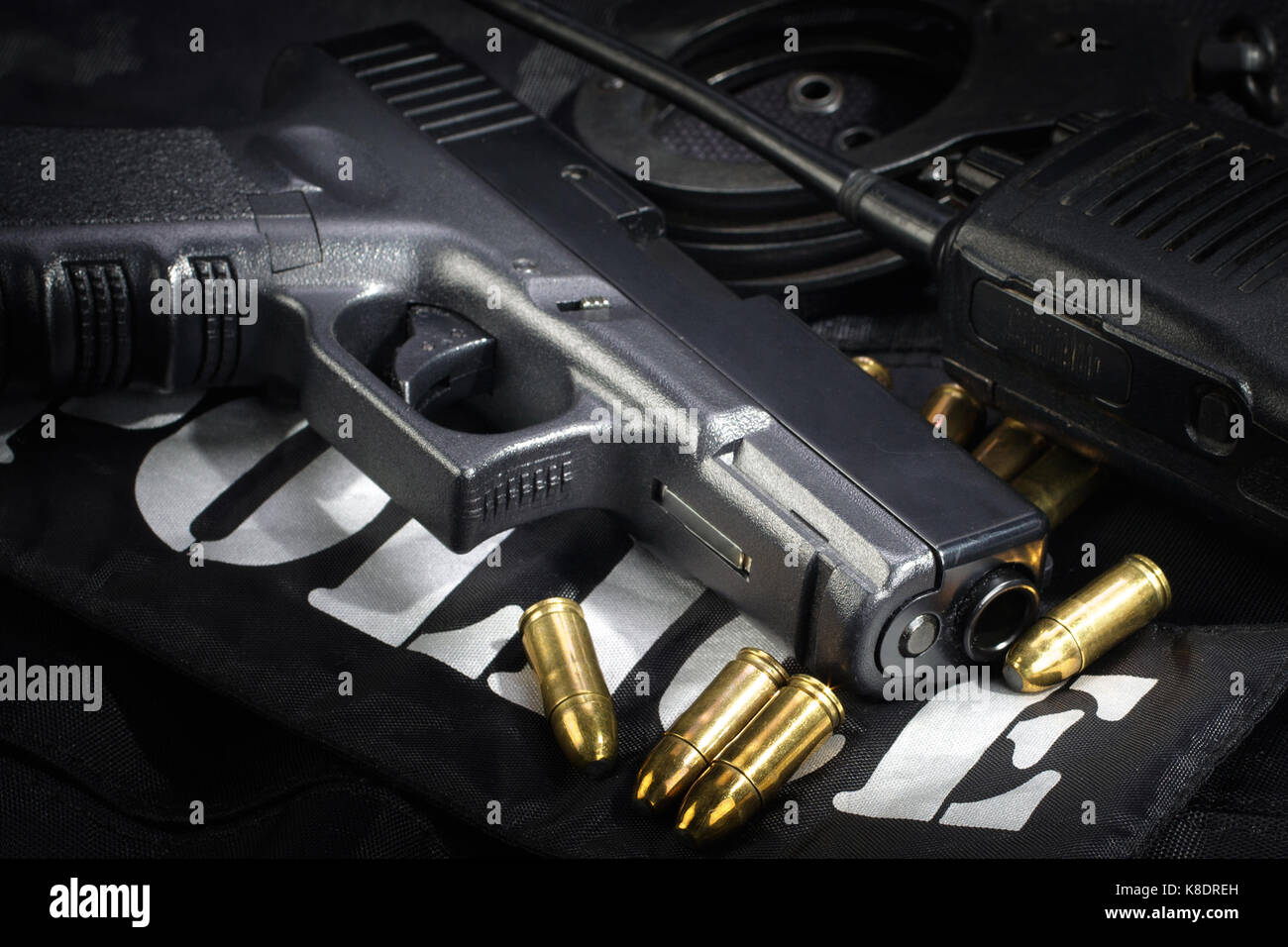Police weapon and equipment on black uniform background Stock Photo - Alamy