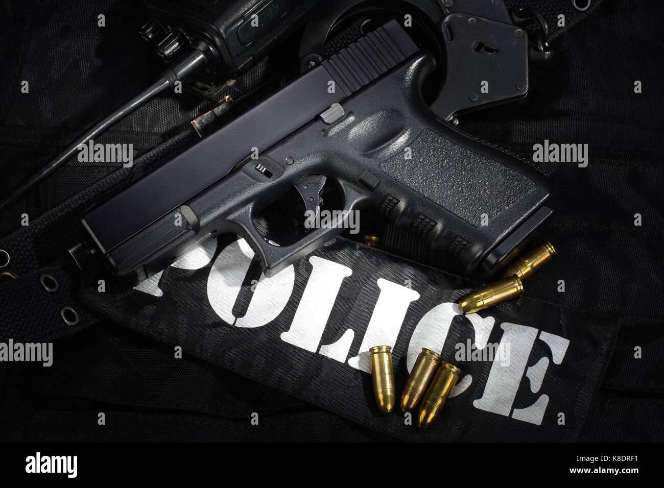 Police weapon and equipment on black uniform background Stock Photo - Alamy