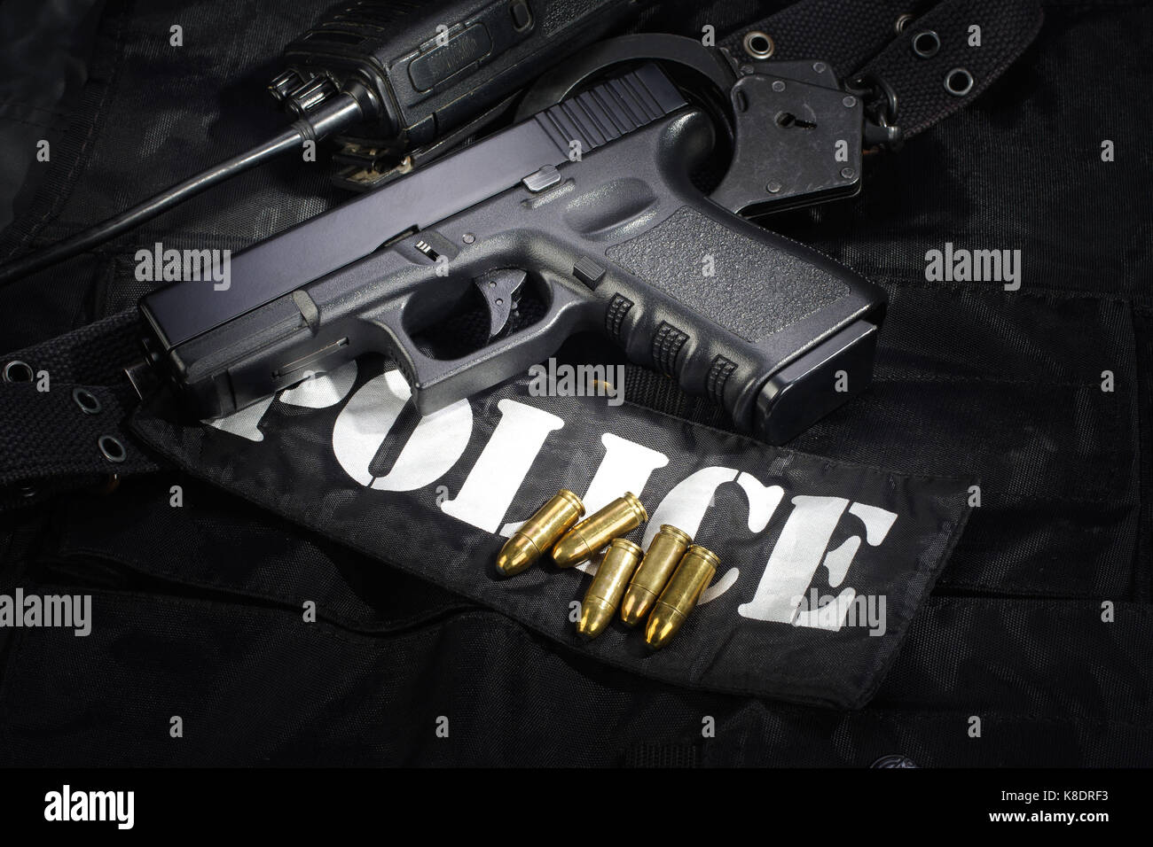 Police weapon and equipment on black uniform background Stock Photo - Alamy